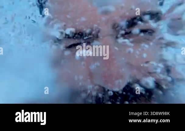 Bearded male submerging underwater, generating rhythmic stream of ...