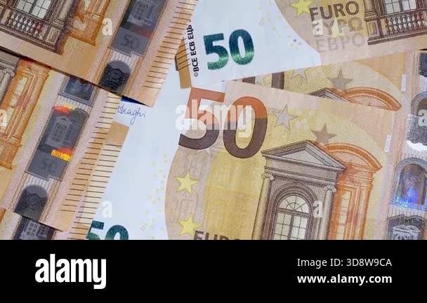 50 euro banknotes neatly spreading across white surface, filling entire ...