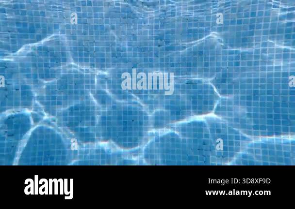 Shimmering blue caustics dancing across textured pool tiles, creating ...