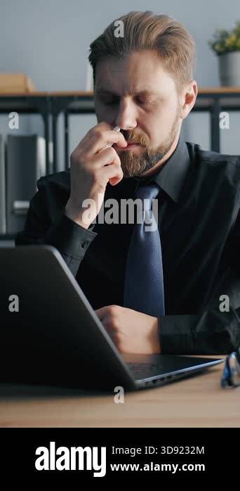 Man uses cold office spray while working at his desk to stay refreshed ...