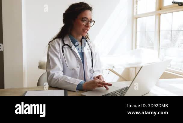 General practitioner participating in videocall at clinic office ...