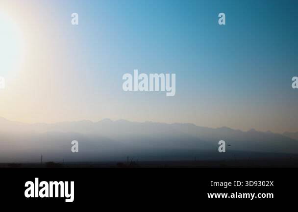 The plane descends for landing against the backdrop of mountains. The ...
