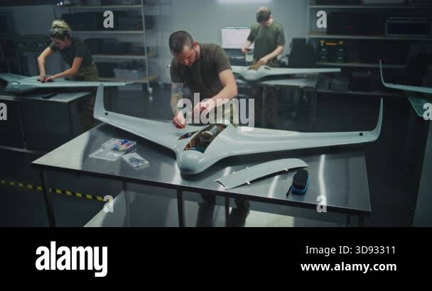Focused Engineers Meticulously Installing Internal Components and ...