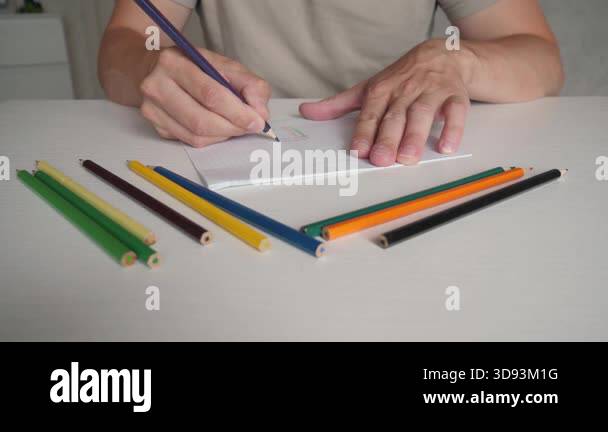 Calm environment for artistic expression, male hand drawing with two ...