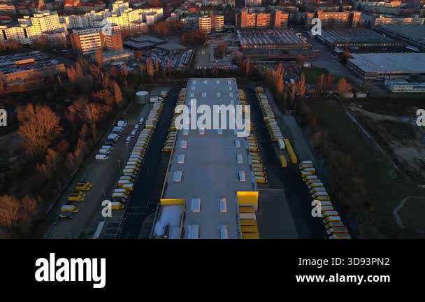 Aerial view showing many yellow delivery vans parked at a large ...