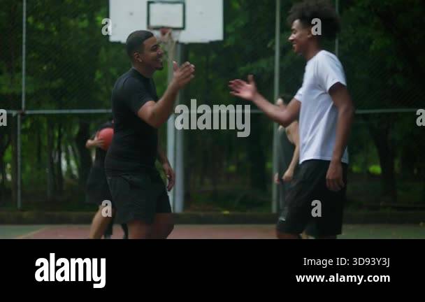 Two friends greeting each other with a friendly handshake on outdoor ...