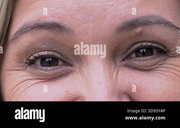 Close-Up Of Female Eyes Looking At Camera With Smile Showing Fine ...