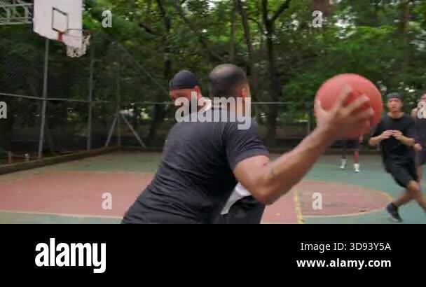 Teammates passing basketball and attempting to score but missing the ...