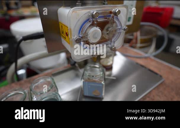 Cesis, Latvia - November 21, 2025: Industrial filling machine operates ...