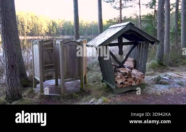 Rustic wooden structures, including a wood storage shed and an outdoor ...