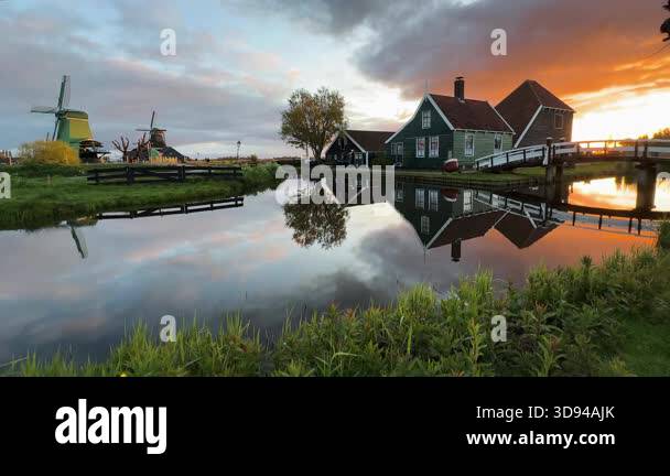 traditional Dutch village Zaanse Schans over water at summer sunset ...