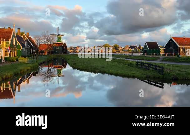 traditional Dutch village Zaanse Schans over water at summer sunset ...