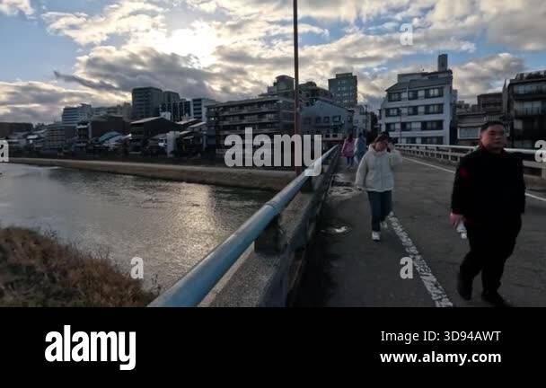 People walking across a bridge in a city Stock Video Footage - Alamy