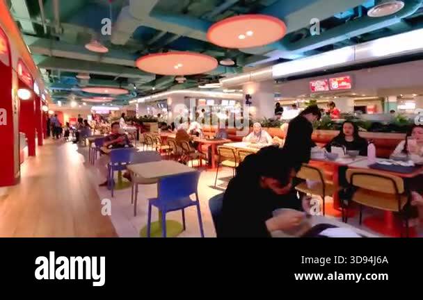 High quality 4K footage of People are enjoying dinner at the mall with ...