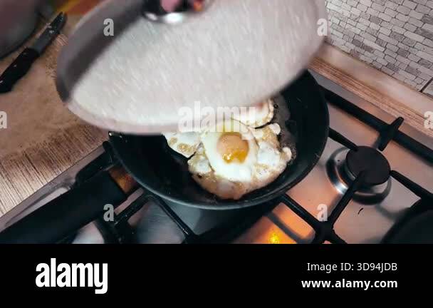 Fried eggs in a frying pan. 4K Fried eggs in a frying pan for breakfast ...