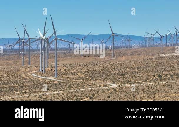 Aerial view of wind turbines spread across the Mojave Desert in ...