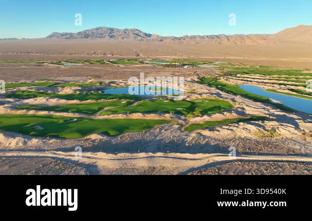 Lush green golf course fairways wind through the desert near Las Vegas ...