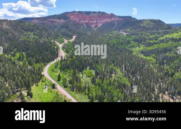Aerial fly over Cedar Canyon Road in Utah showcases lush forest ...