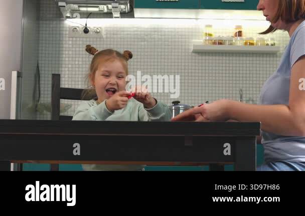 Bottom view of Caucasian child is practicing clay sculpture at a table ...