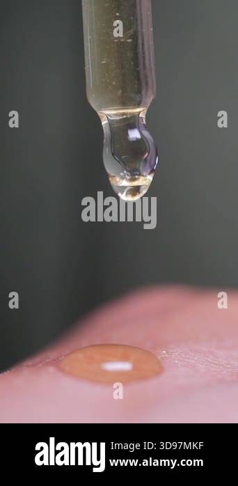 A serum drop is about to touch the skin, showcasing its hydrating ...