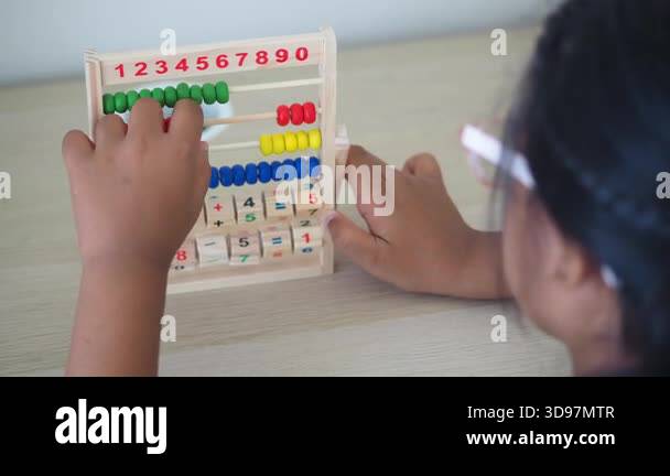 A child uses an abacus to practice math skills and solve problems Stock Video Footage - Alamy