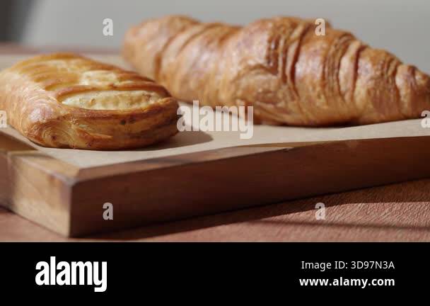 Enjoy delicious pastries served on a wooden board at a cozy cafe Stock ...