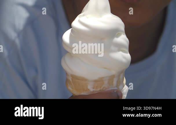 Savoring creamy soft serve ice cream while relaxing outdoors Stock ...