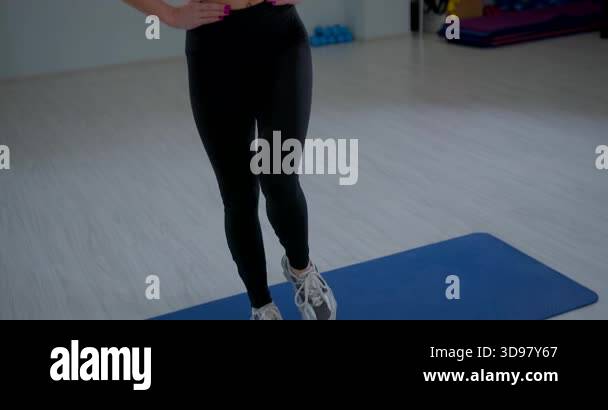 Active lady wearing sportswear preparing for exercise training indoors ...