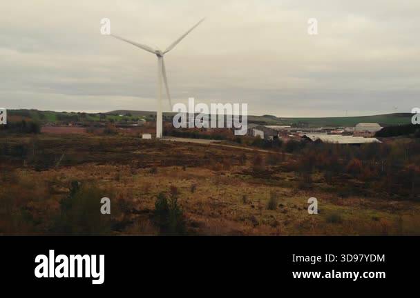 Solitary wind turbine spinning in rural British Countryside wide aerial ...