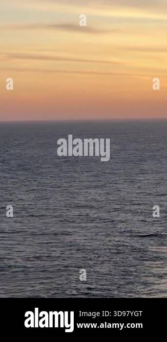 Video of a charming sunset over the sea with warm colors and gentle ...