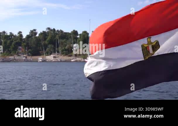 The Egyptian flag waves proudly on a boat cruising the Nile River in ...