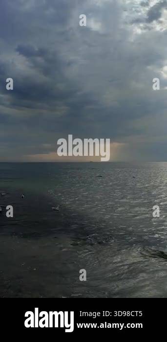 Rain in sea. Rain falling in sea. Cloudy, rainy, stormy weather at sea ...