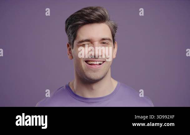 Handsome man blinking with eye, flirting and smiling to camera. Guy in ...