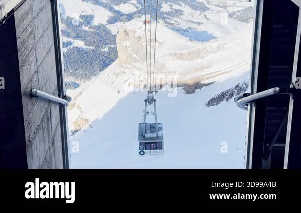 Mountain cable car with passengers to Glacier 3000 summit, featuring ...
