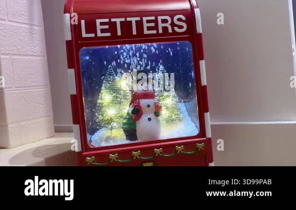 Christmas decoration with a snowman inside a red letters mailbox ...
