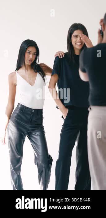 Professional photographer directing two beautiful female models posing ...