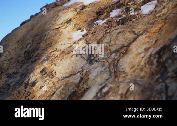 View of jagged mountain rock displays rough patterns with small bright ...