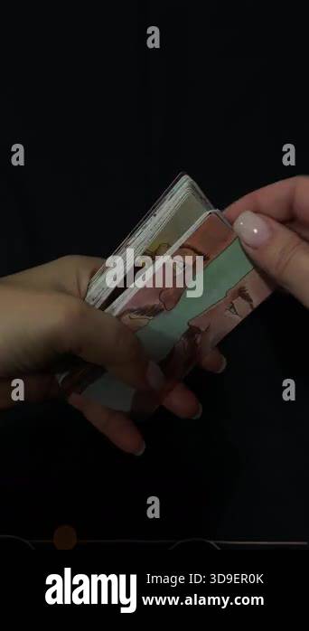 Tarot card divination on a wooden table with candlelight, esoteric ...