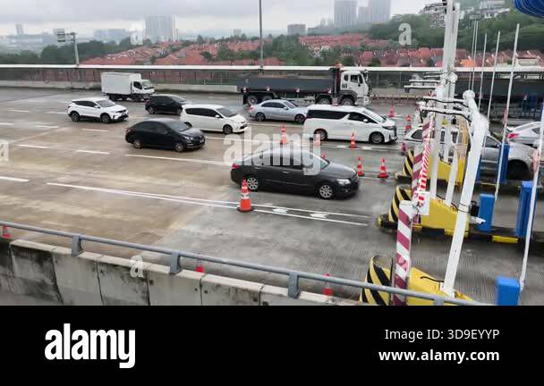 Heavy traffic in Malaysia queuing at a toll plaza. Drivers will make ...