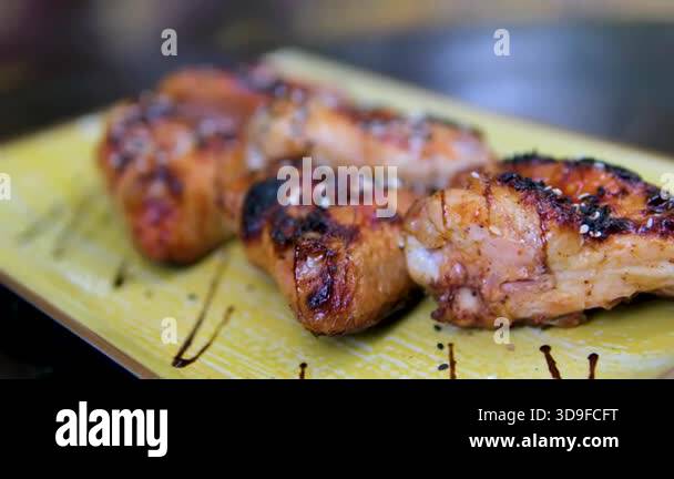 Whole chicken wings grill strung on a wooden stick grilling on the ...