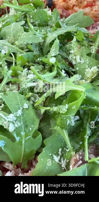 Freshly baked pizza topped with arugula and parmesan. Perfect for ...