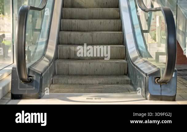 Close up view of moving escalator steps going upward with metallic ...