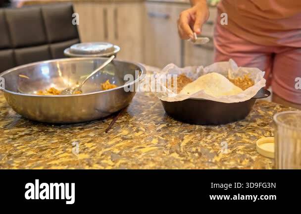 Closeup view of adding dough ingredients and covering with a layer of ...