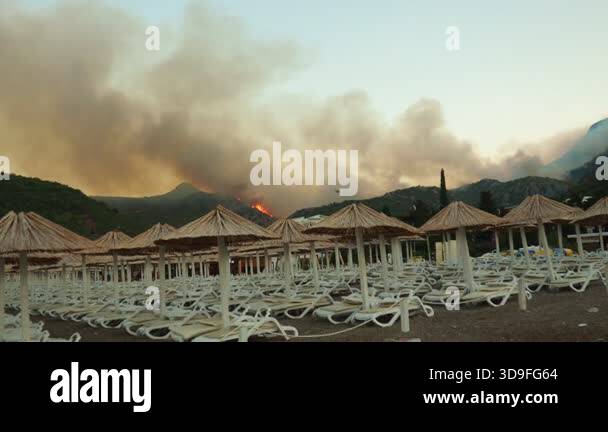 Chan, Montenegro, August 11, 2025: Fire in mountains over sea village ...