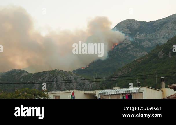 Chan, Montenegro, August 11 2025: Fire in mountains over village ...