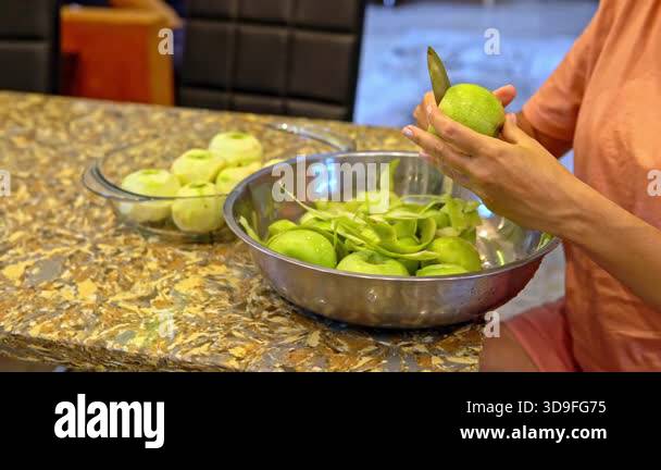 Closeup view of peeling fresh apples with a kitchen knife. Simple home ...
