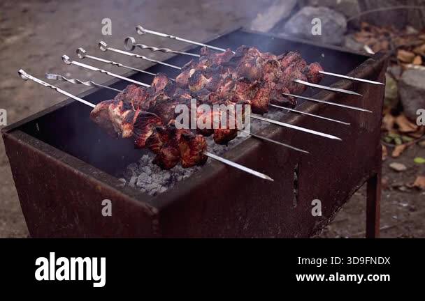 Cooking meat outdoors in the backyard for a large family and their ...