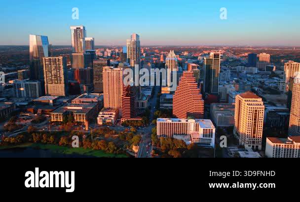Flying over the scenery of Austin, Texas at sunset. Numerous cars move ...