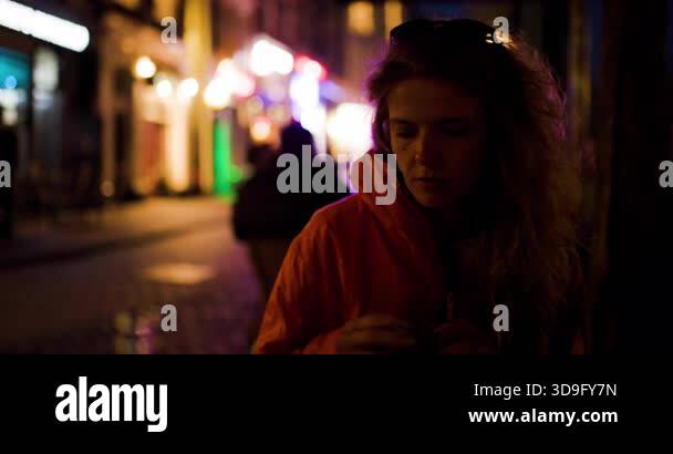 Engaging conversation unfolds in a lively cafe as colorful lights ...