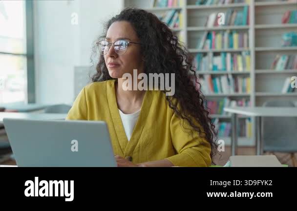 Latina Hispanic woman student use laptop technology library female girl ...